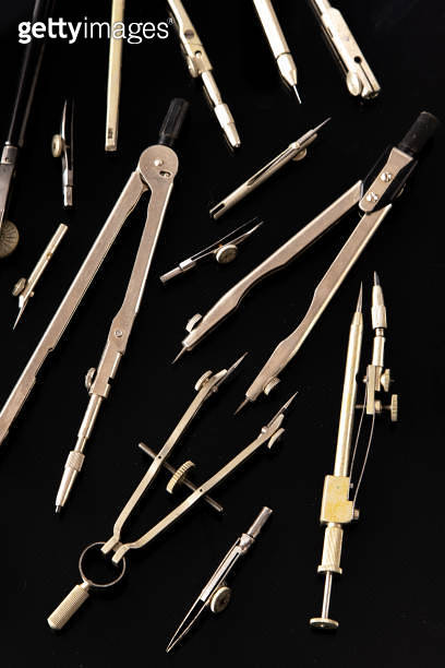 Set of old different compasses. Retro metal compasses and drafting ...