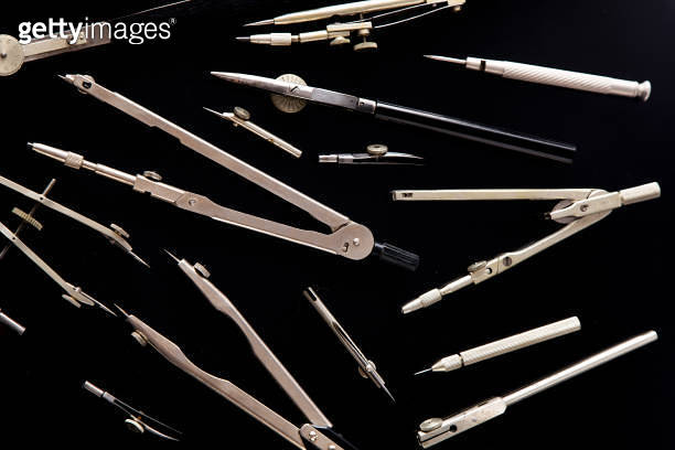 Set of old different compasses. Retro metal compasses and drafting ...