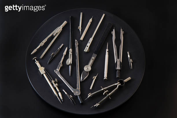 Set of old different compasses. Retro metal compasses and drafting ...