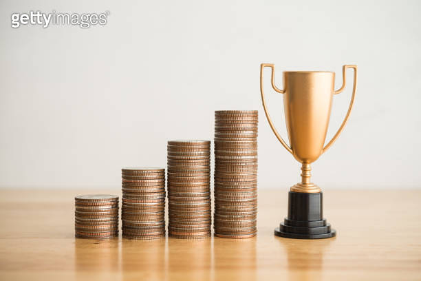 Gold winner trophy and growth chart stack coins on wooden table. 이미지 ...