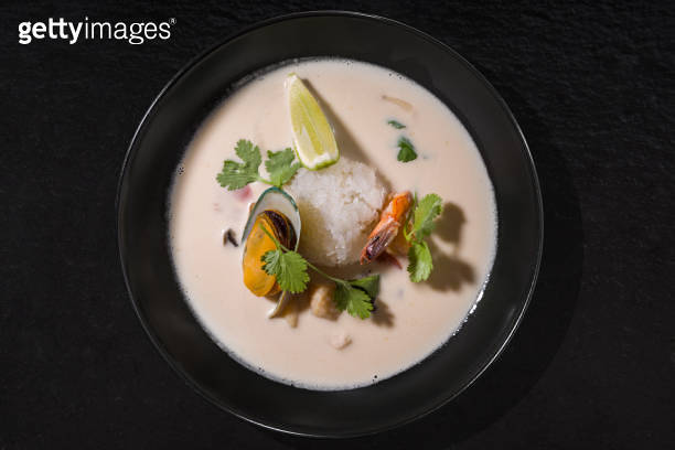 Cream soup slipper with oyster, rice, lemon, parsley, shrimp and fish ...
