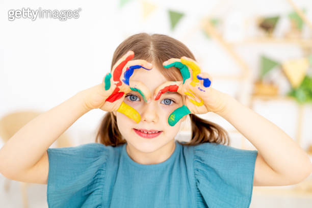 cute little baby girl with colorful painted stained hands in finger ...