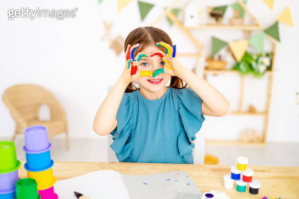 cute little baby girl with colorful painted stained hands in finger ...