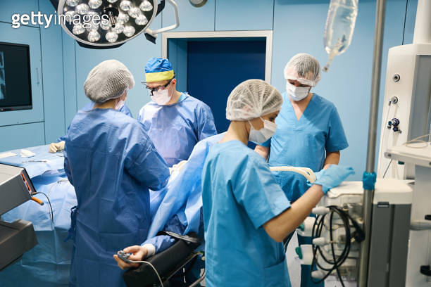 Surgical team performs an operation in a sterile operating room ...
