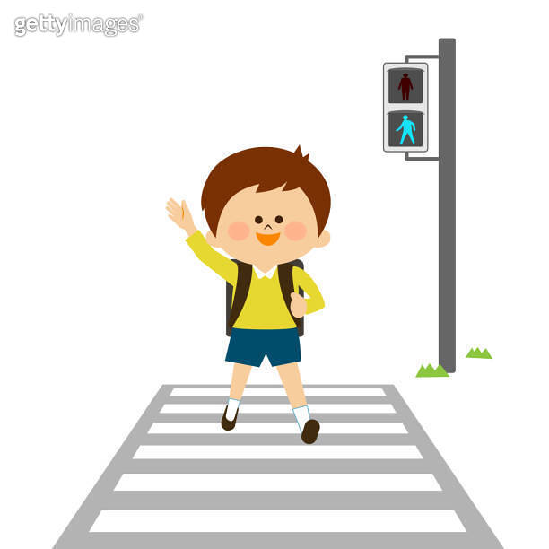 Traffic safety A child crossing a pedestrian crossing with a green ...
