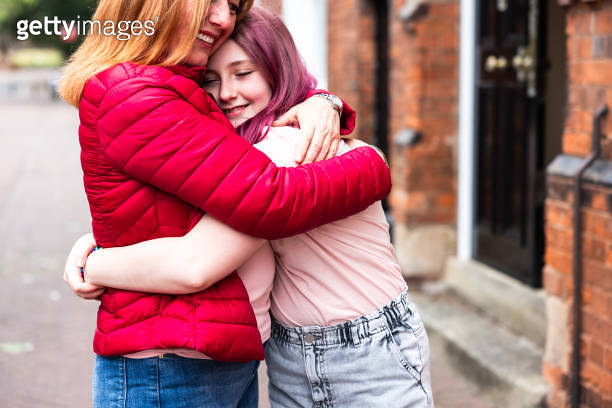 Woman and girl giving lovely hug and smiling 이미지 (1830697529) - 게티이미지뱅크