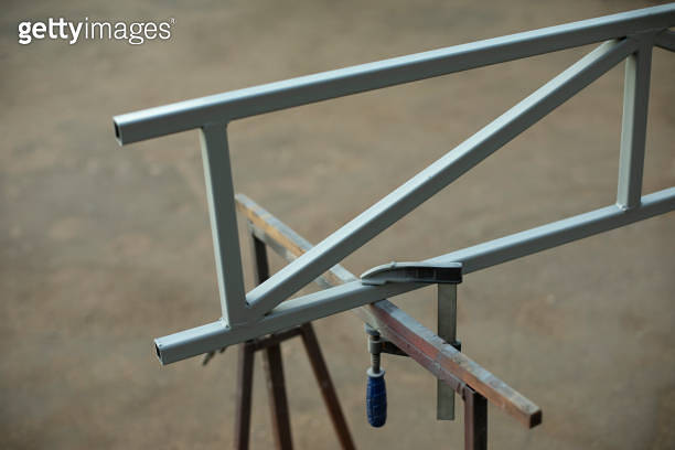 Steel part on street. Metal profile with holder. Steel construction ...