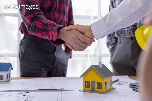 Real estate agents and construction team leaders work together. View ...