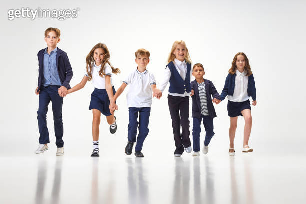 Group of stylish children, boys and girls, pupils in school uniform ...