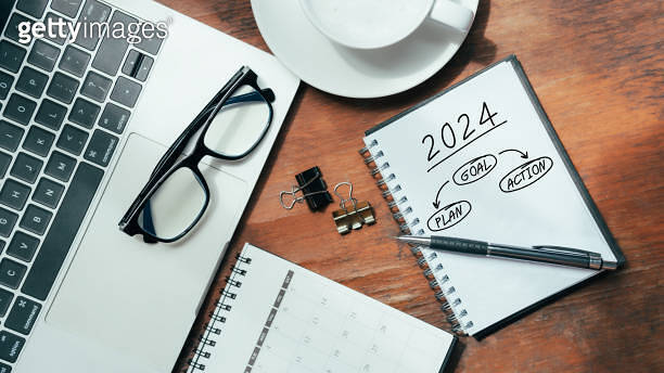 New Year's resolutions 2024 on wooden table. Goals, plans and action ...