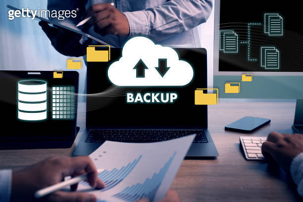 Man uses computers. Online backup technology, data storage on a laptop ...