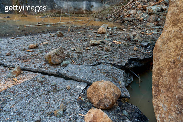 A huge rock fell from the mountains onto the road, destroying the ...