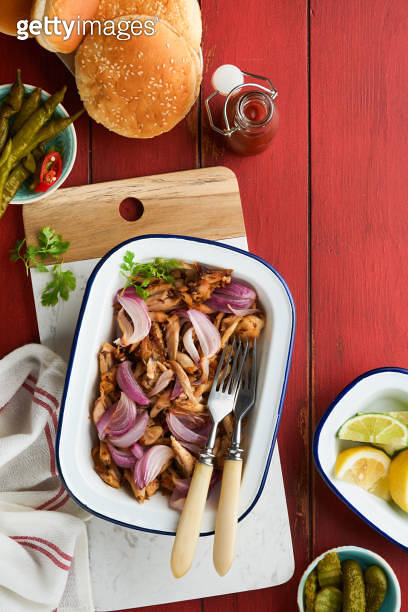 Pulled bbq chicken with baked onions on serving platter, bbq corn ...