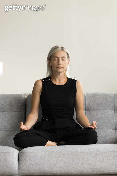 Serious tranquil senior woman meditating at home, keeping zen 이미지 ...