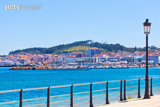 Ribeira townscape and harbor seen from beautiful Coroso beach, A Coruña ...