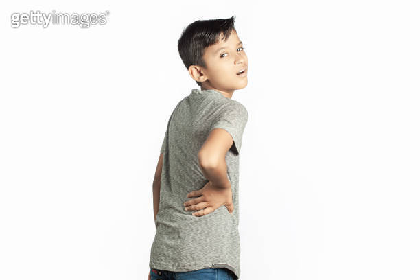 slim boy holding his lower back due to pain in the spinal cord 이미지 ...