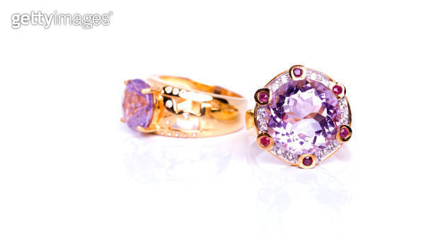 Closeup display of two exquisite rings adorned with gleaming amethyst ...