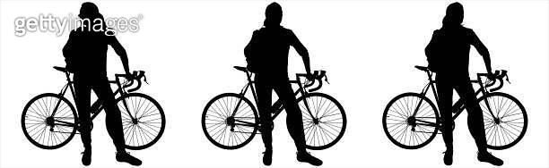 A girl with a large backpack behind her back is standing near the bike ...