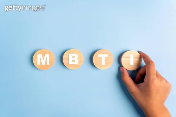 Wooden blocks with the letters MBTI on blue background. Personality ...