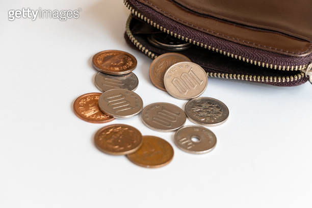 Coins spilled on the desk from a coin purse (1479611119) - 게티이미지뱅크