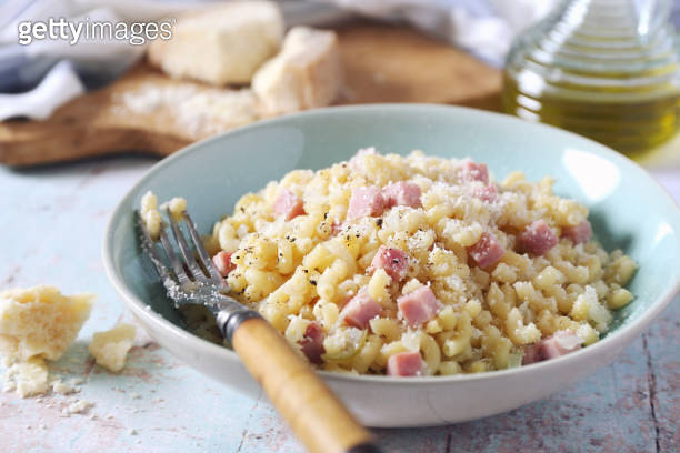 Italian Cuisine. Stortini pasta risotto with fresh ham cubes, grated ...