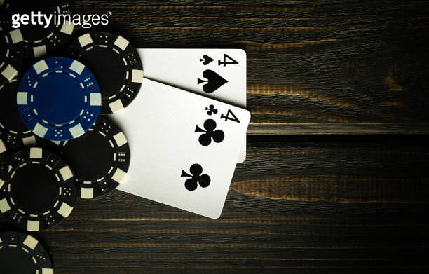Playing poker with a winning combination of one pair. Cards with chips ...