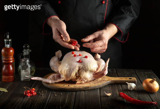Cooking chicken in the kitchen with the hands of a chef. Before baking ...