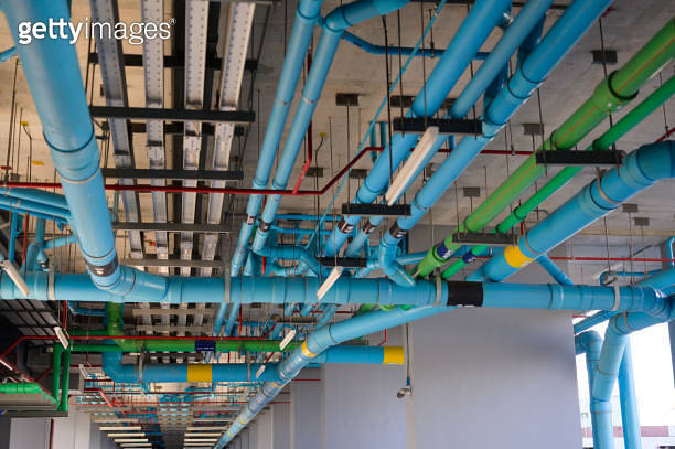 Open system Water mains and drainage under ceiling of building in ...