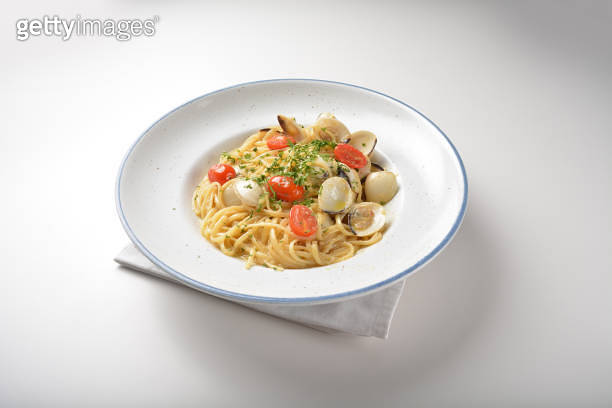stir fried olive oil mixed seafood clam shell pasta in aglio olio style ...