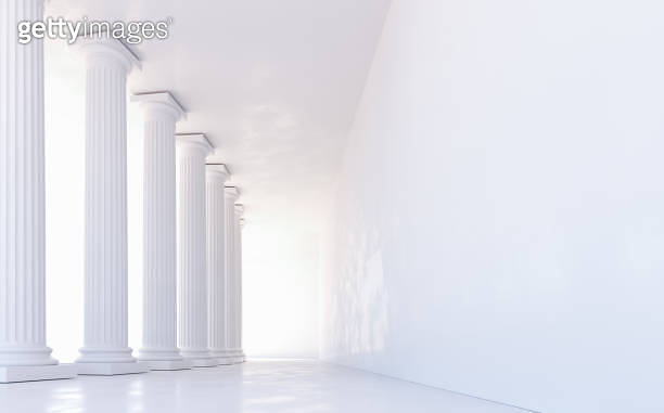 White columns in a row surrounding a corridor with a curved wall ...