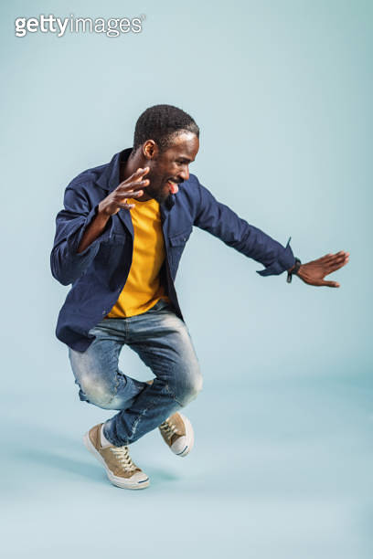 Confident Happy Smiling African Man Dancing And Enjoying In The Studio ...