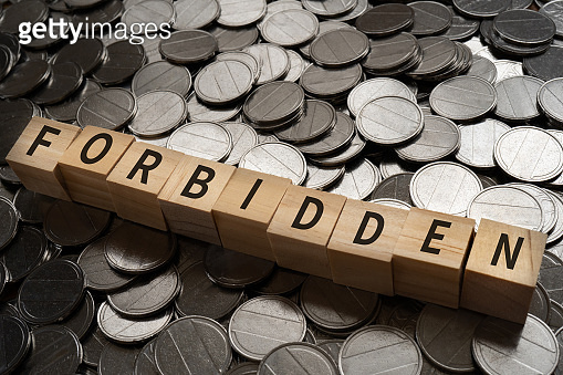 Wooden blocks with "FORBIDDEN" text of concept and coins. (1455595294 ...