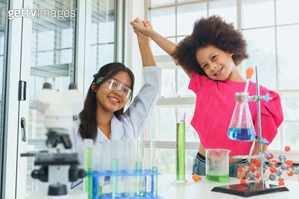 School children doing science experiments in school lab, children ...