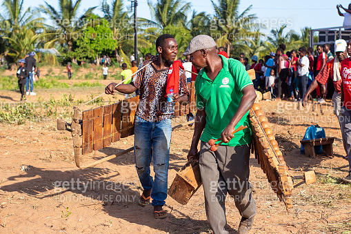 Musicians carry traditional wooden xylophone-like instrument from ...