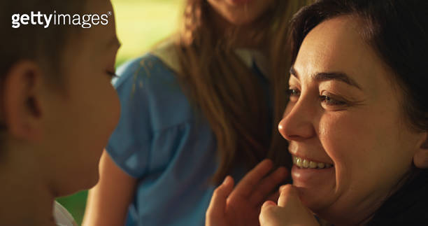 Happy mother caressing son on nature close up. Cute boy touching mommy ...
