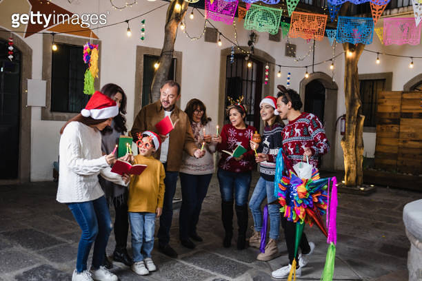 Mexican Posada, hispanic family Singing carols in Christmas celebration ...