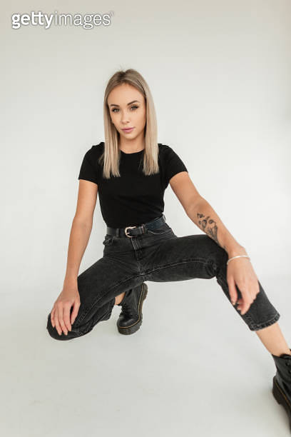 Stylish Young Blond Girl In Black Clothes With A T Shirt Black Jeans