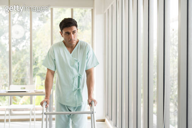 Patient man using walker at hospital ward. Patient man using walker for ...