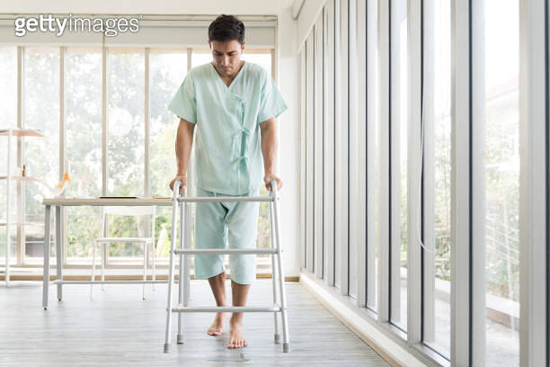 Patient man using walker at hospital ward. Patient man using walker for ...