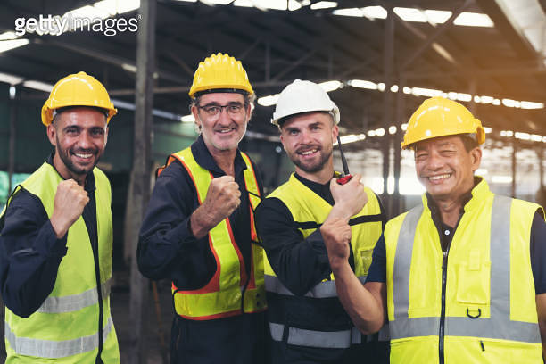 Group of male factory workers standing and show their hands after ...