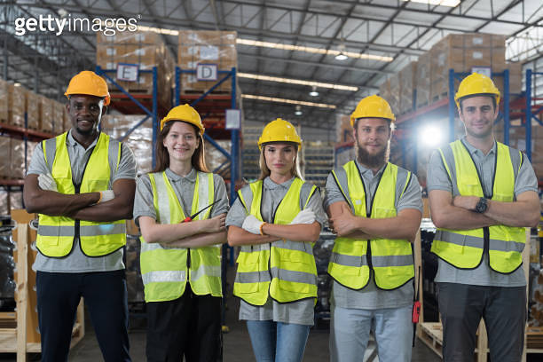 Group of diverse warehouse workers standing with crossed arms in ...