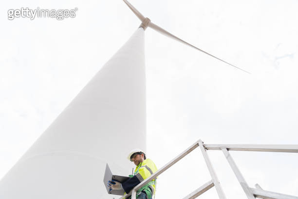 Male engineer working with plan inspecting or maintenance of wind ...
