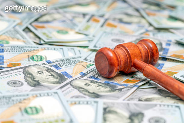 Judge hammer on American money background. Fraud tax fines. Law ...