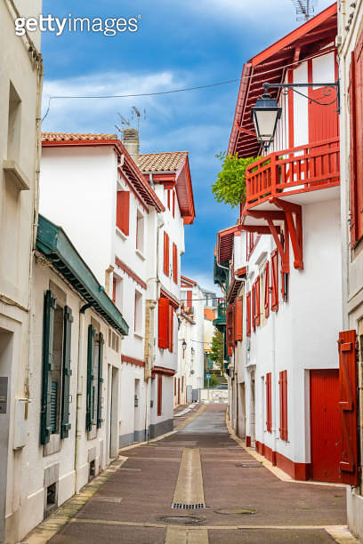 Colored buildings of a narrow street in the city center of Saint-Jean ...