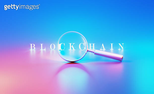 Metallic Magnifier And Blockchain Word Illuminated By Blue And Pink ...