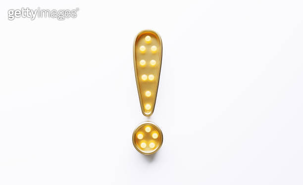 Gold Colored Exclamation Point Illuminated By Light Bulbs on White ...