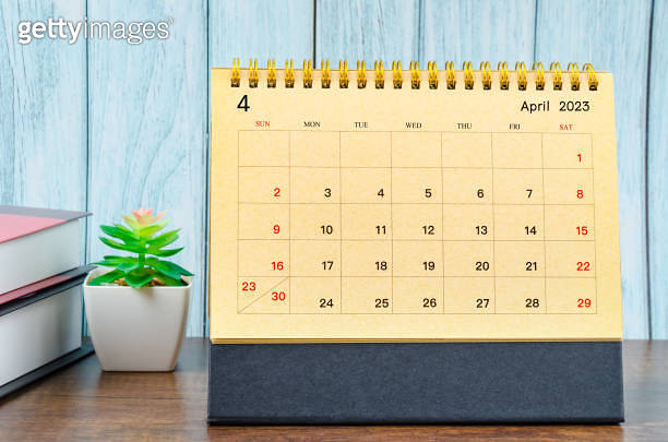 The April 2023 Monthly desk calendar for 2023 year with the books on ...