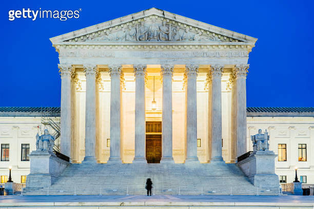 The Supreme Court of the United States with a silhouette of a person in ...