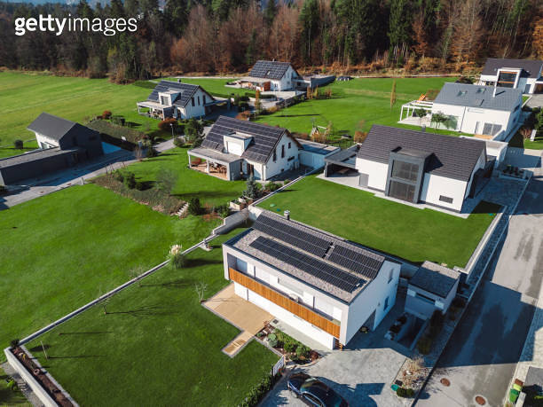 Low aerial close view new dense rural housing development, mostly grey ...