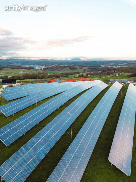 Aerial view of a solar farm in the countryside, on a hill near vineyard ...